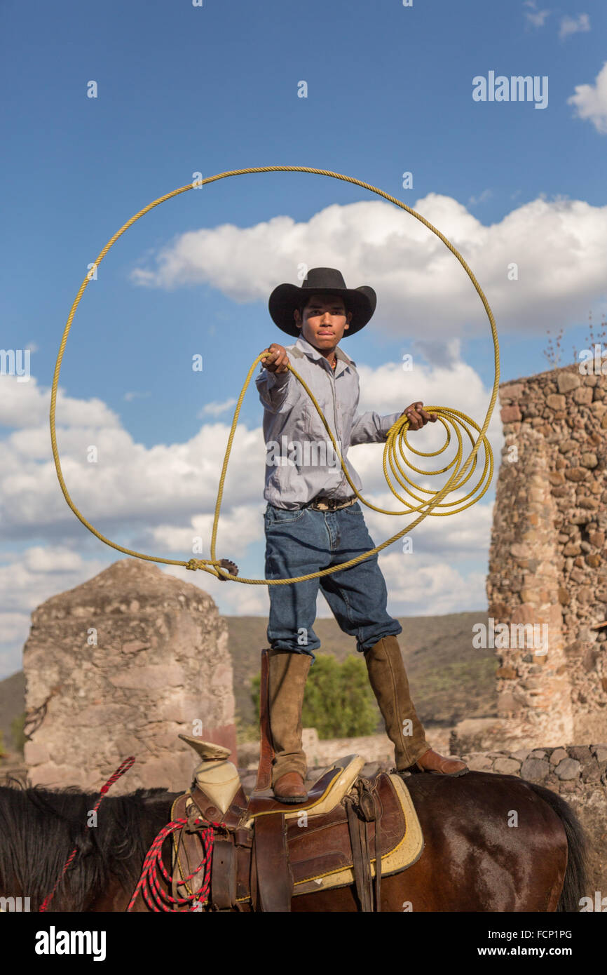 A Mexican charro or cowboy practices roping skills on his horse before ...