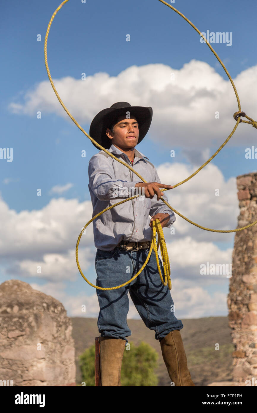 A Mexican charro or cowboy practices roping skills on his horse before ...