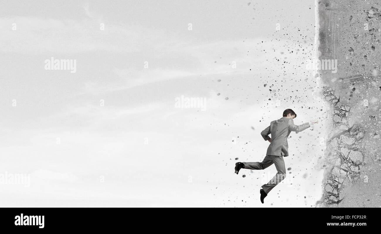 Businessman breaking stone wall with karate punch Stock Photo - Alamy