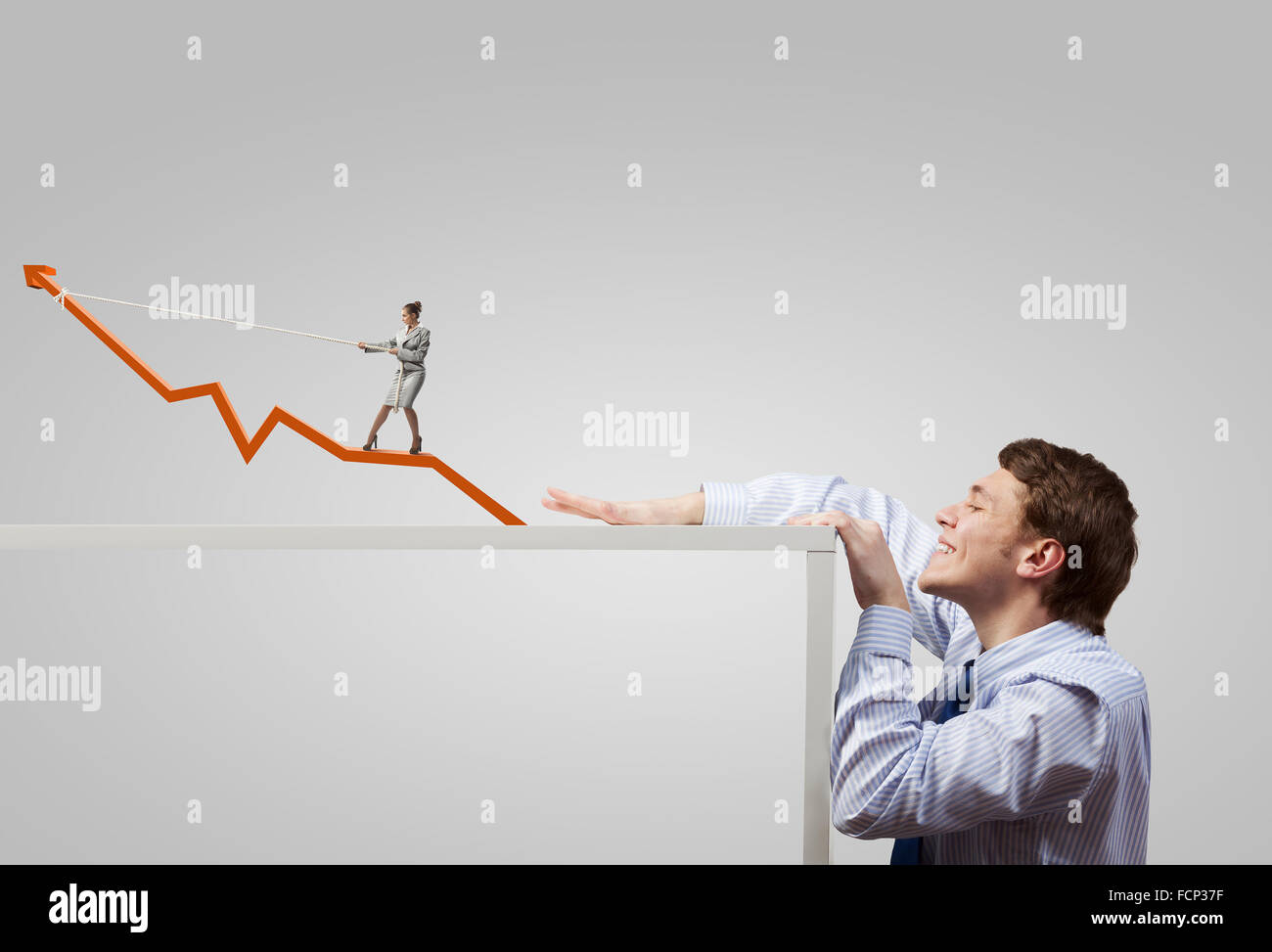 Young man looking from under table on woman pulling arrow graph Stock ...