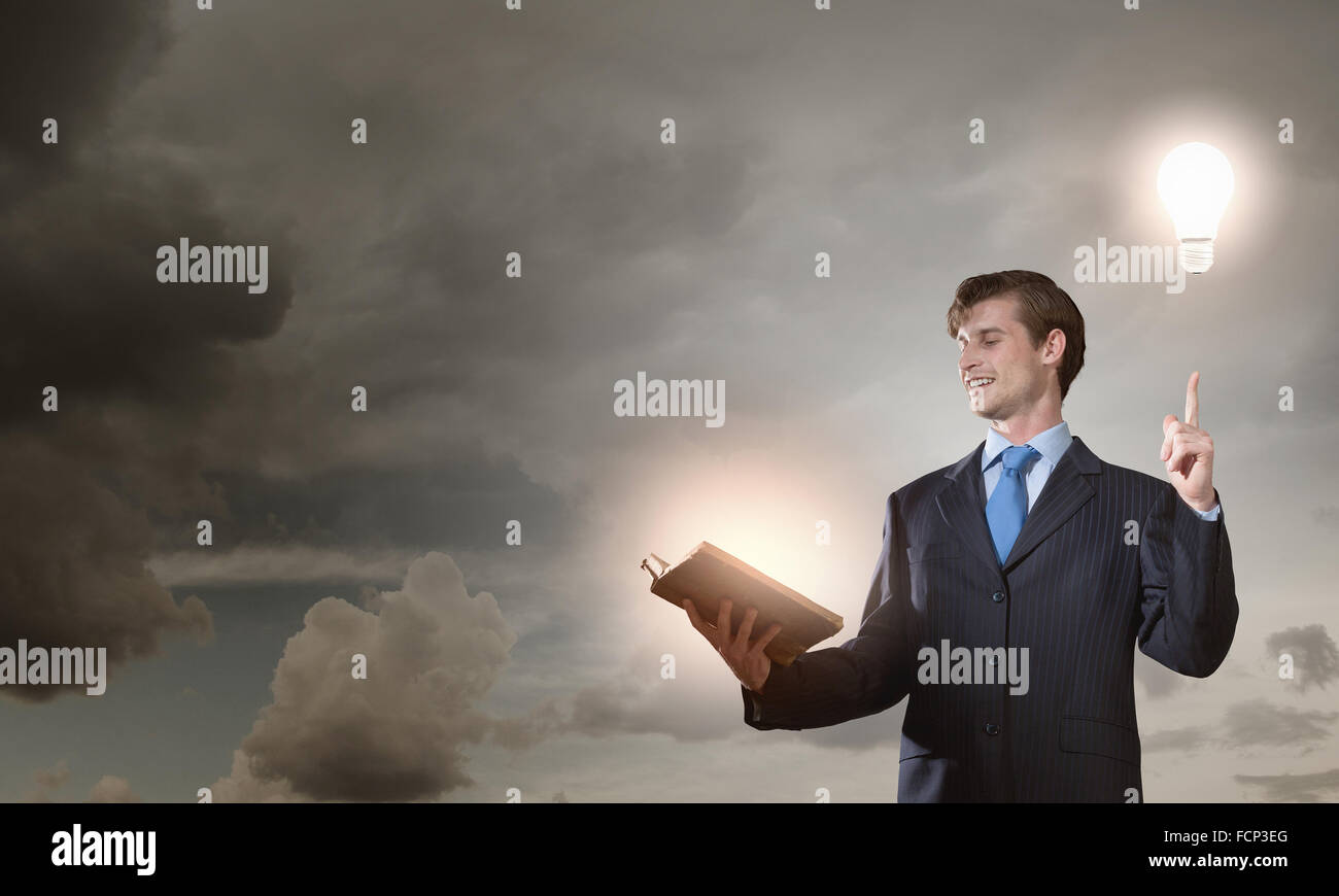 Young handsome man in suit reading old book Stock Photo - Alamy