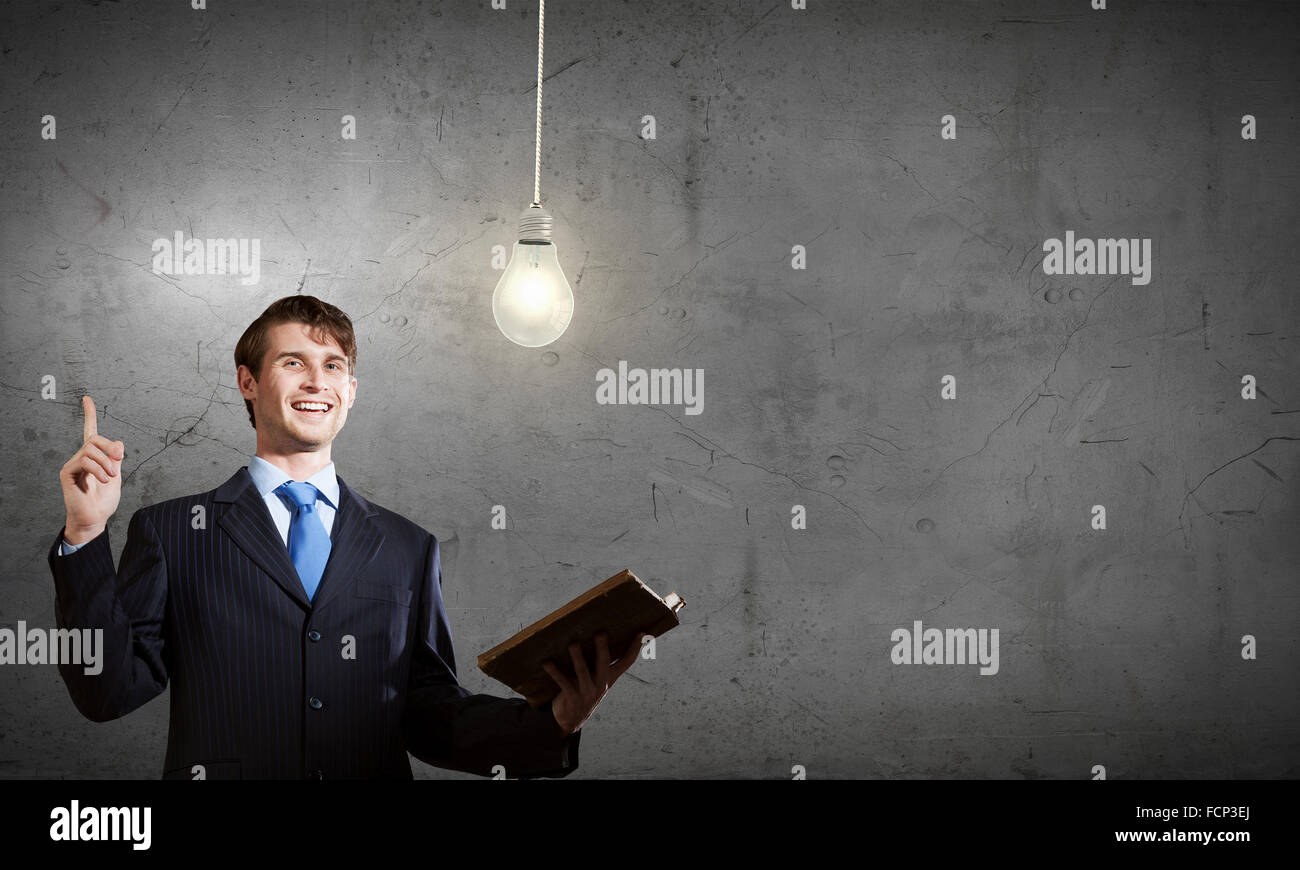 Young handsome man in suit reading old book Stock Photo - Alamy