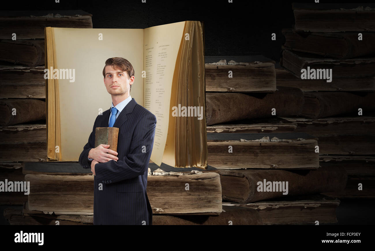 Young handsome man in suit reading old book Stock Photo - Alamy