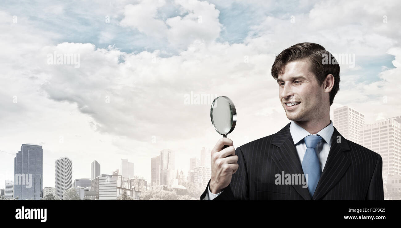 Man magnifying glass smiling hi-res stock photography and images - Alamy