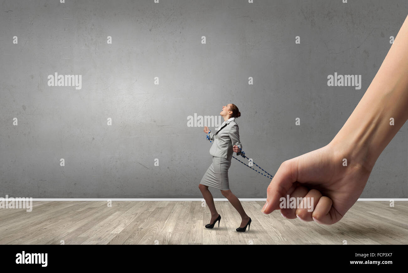 Young businesswoman with ropes on hands trying to escape Stock Photo ...