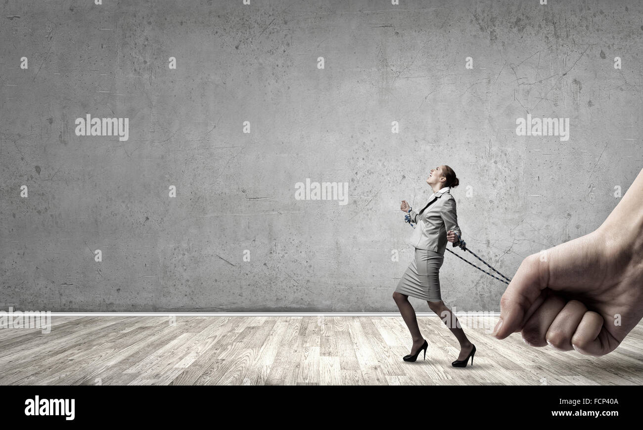 Young businesswoman with ropes on hands trying to escape Stock Photo ...