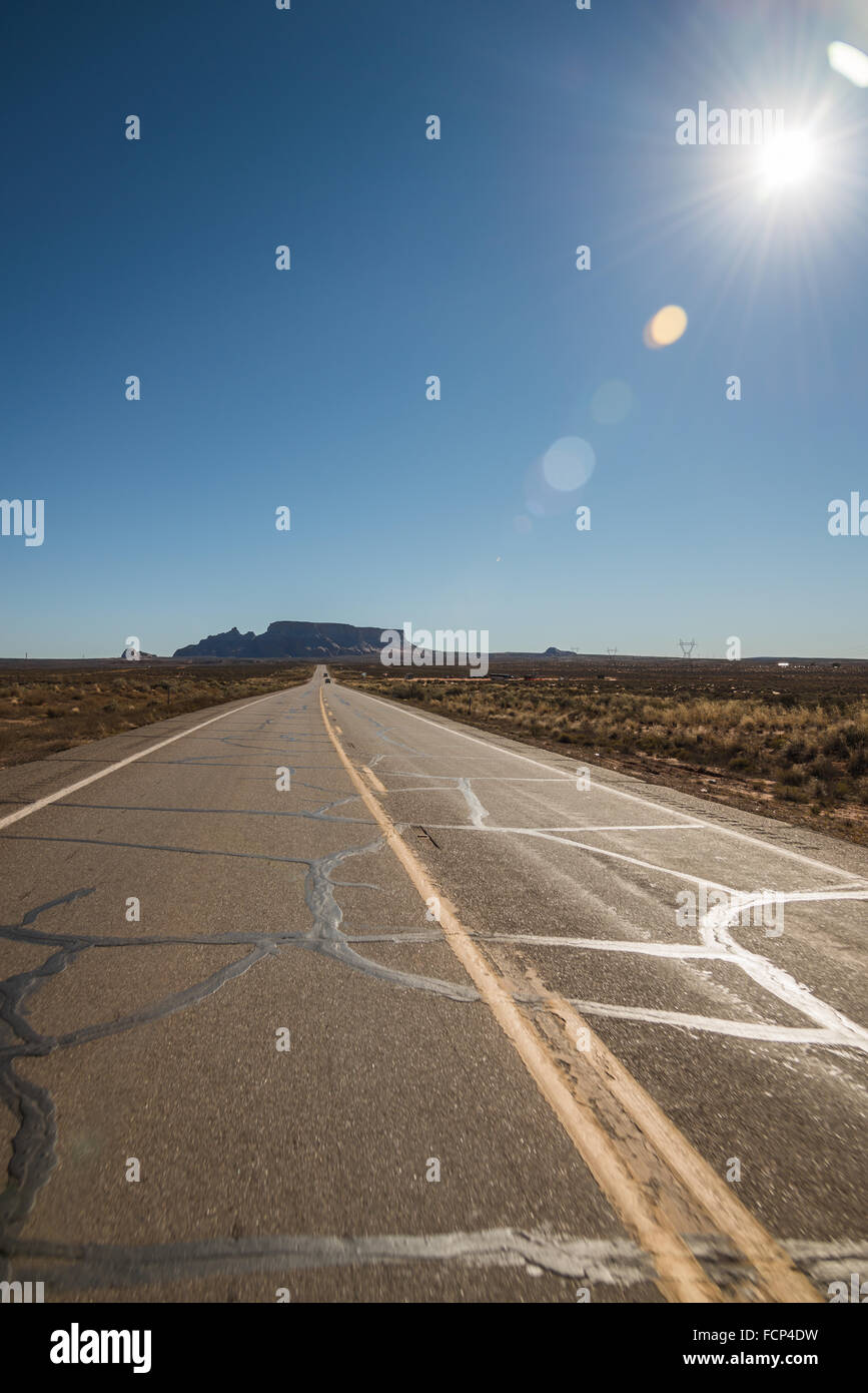 Drive along the road with sun burst and flare Stock Photo - Alamy