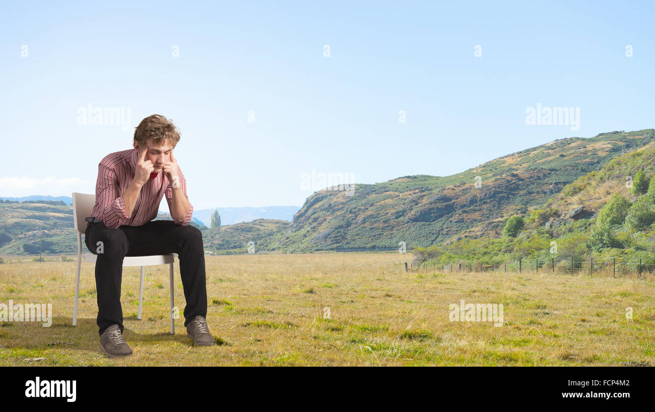 Depressed man sitting on a chair all alone Stock Photo - Alamy