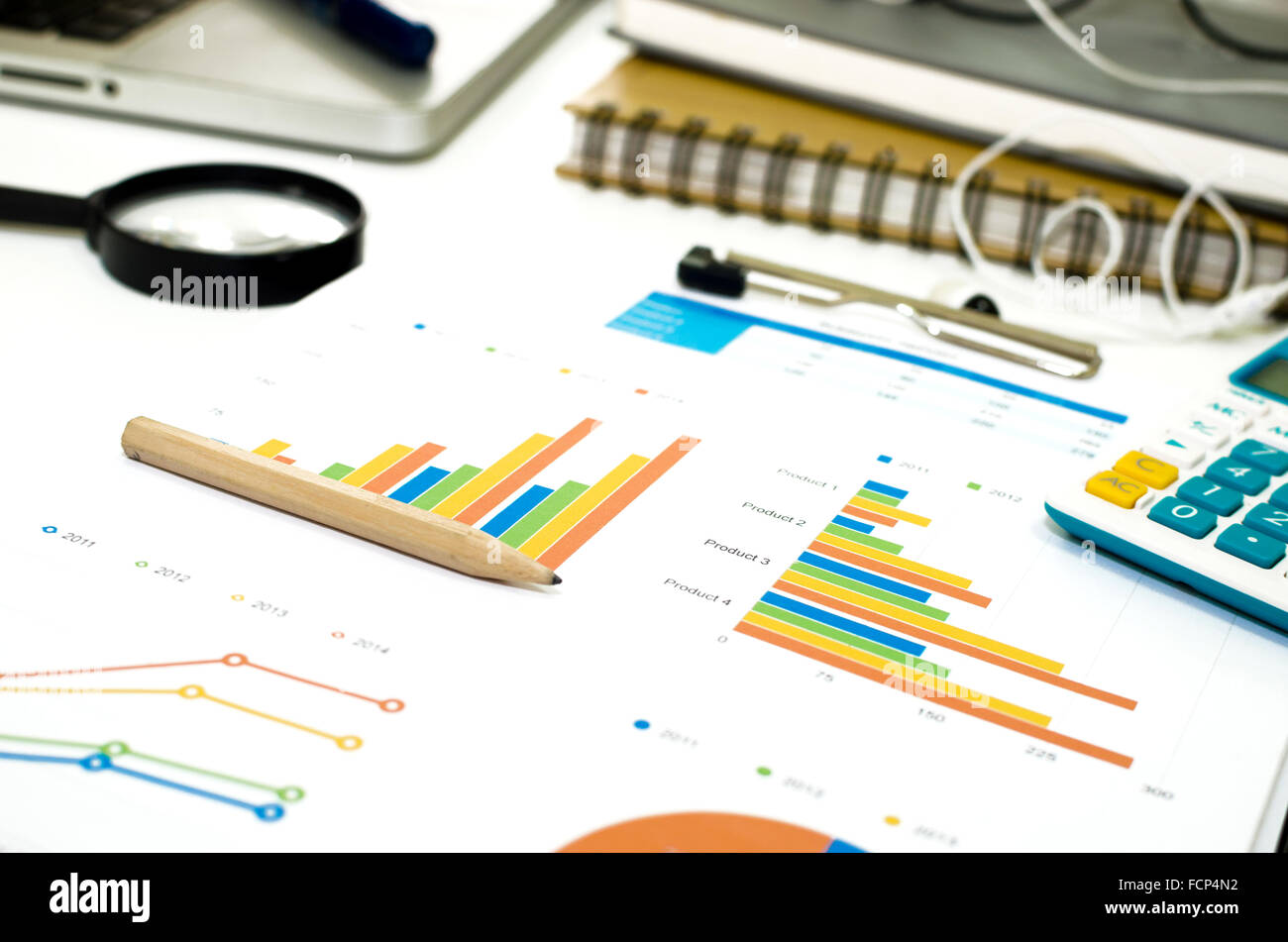 Laptop on Desk office and Graph analysis spreadsheet Stock Photo - Alamy