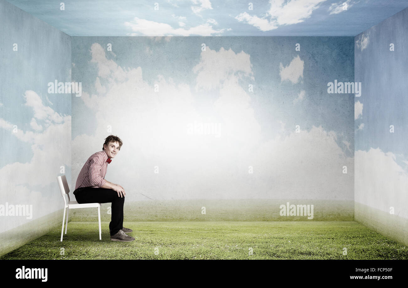 Young funny teenager guy sitting in chair Stock Photo - Alamy