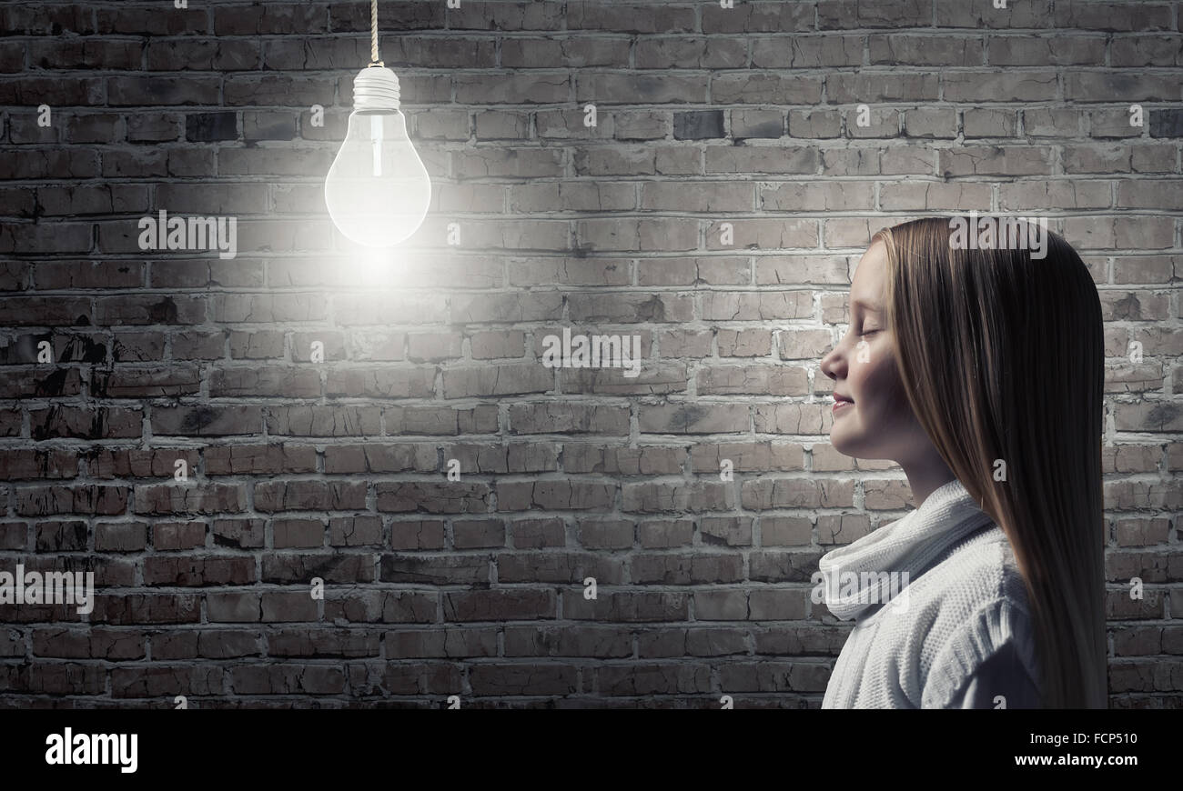 Side view of girl of school age looking at brain above Stock Photo - Alamy