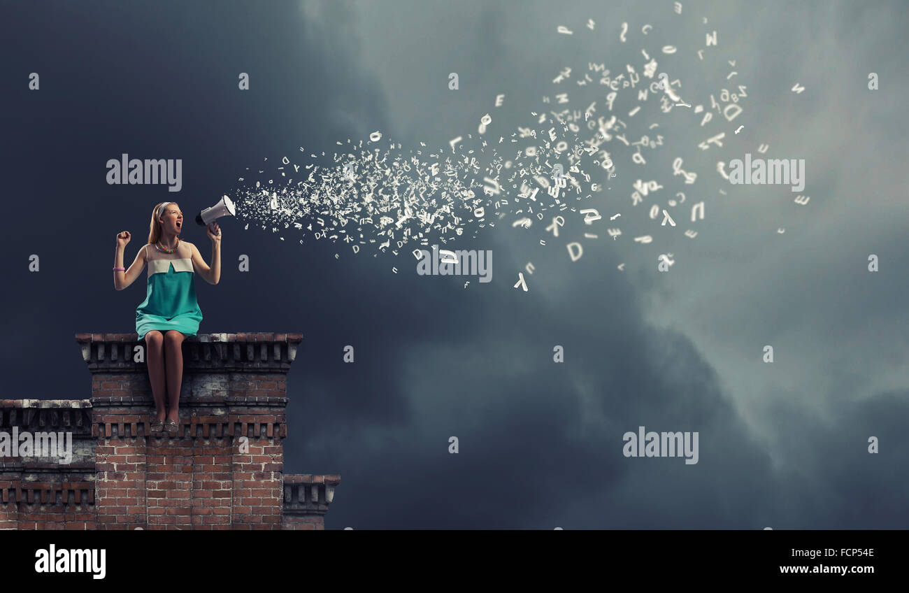 Young woman sitting on roof and screaming in megaphone Stock Photo - Alamy