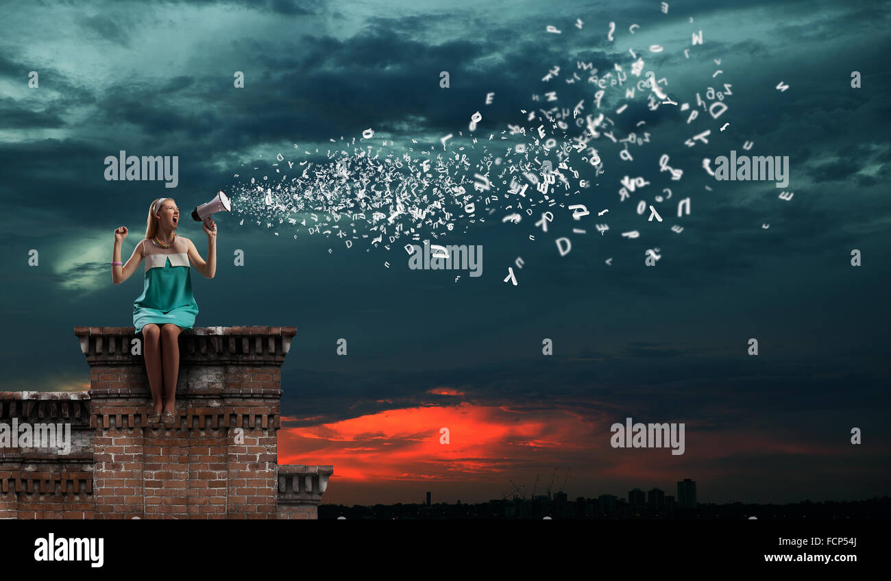 Young woman sitting on roof and screaming in megaphone Stock Photo - Alamy