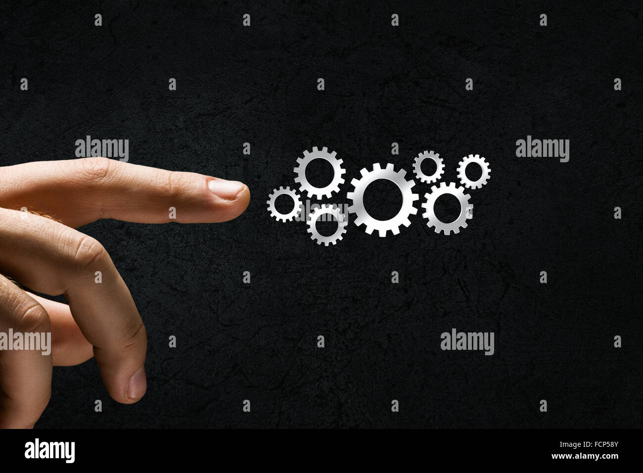 Close up human hand pointing at gears mechanism Stock Photo - Alamy