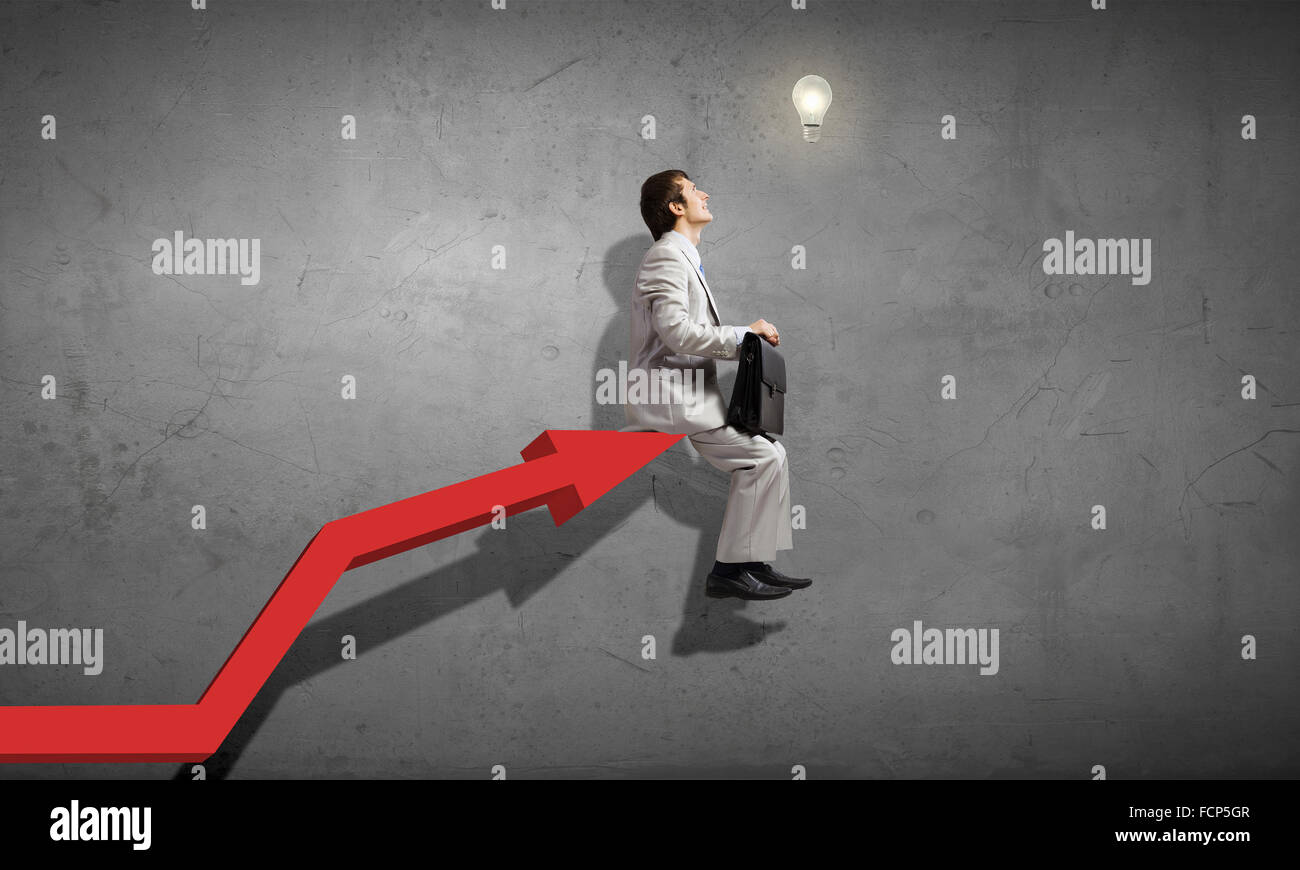 Young businessman sitting on top of growing graph Stock Photo - Alamy
