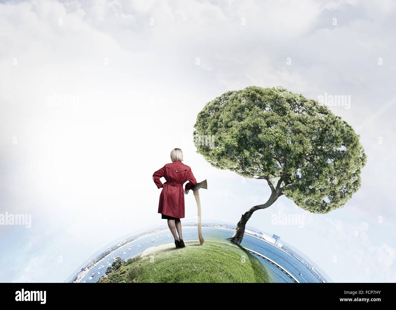 Blond woman in red coat with axe and green tree Stock Photo - Alamy