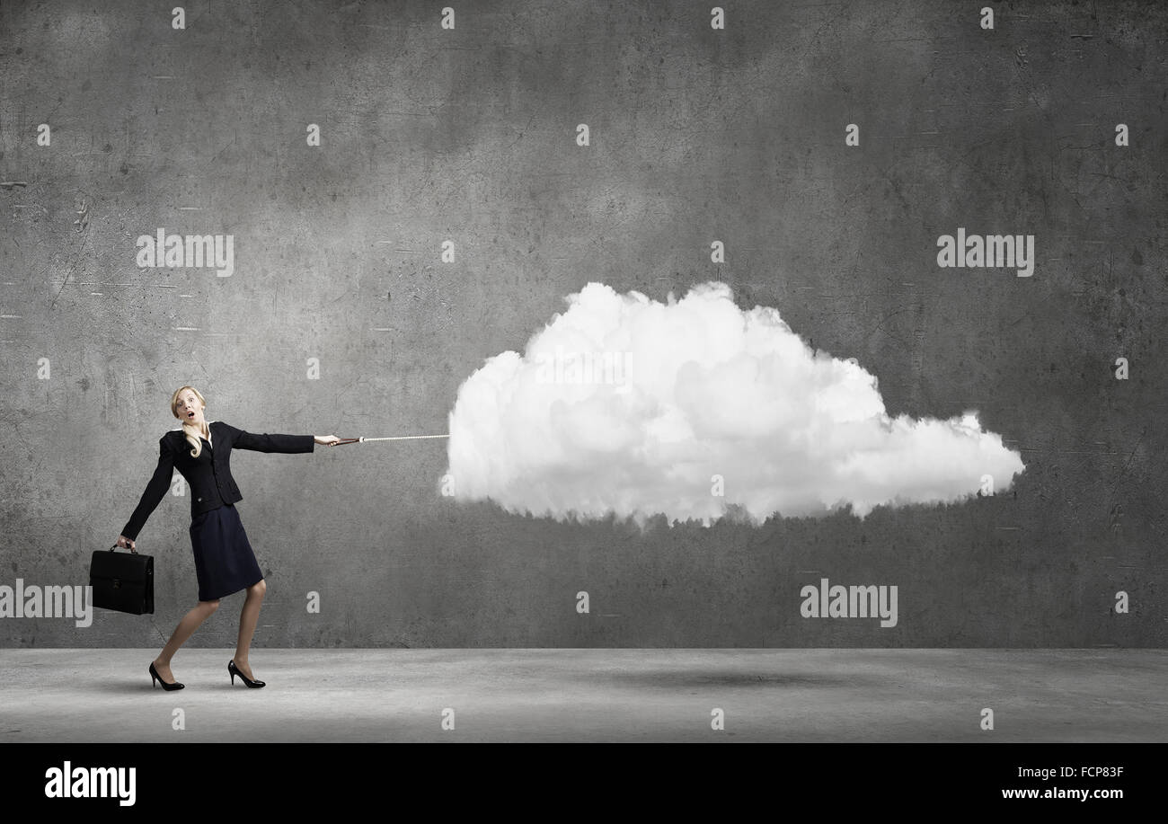 Young businesswoman with suitcase pulling cloud on lead Stock Photo - Alamy