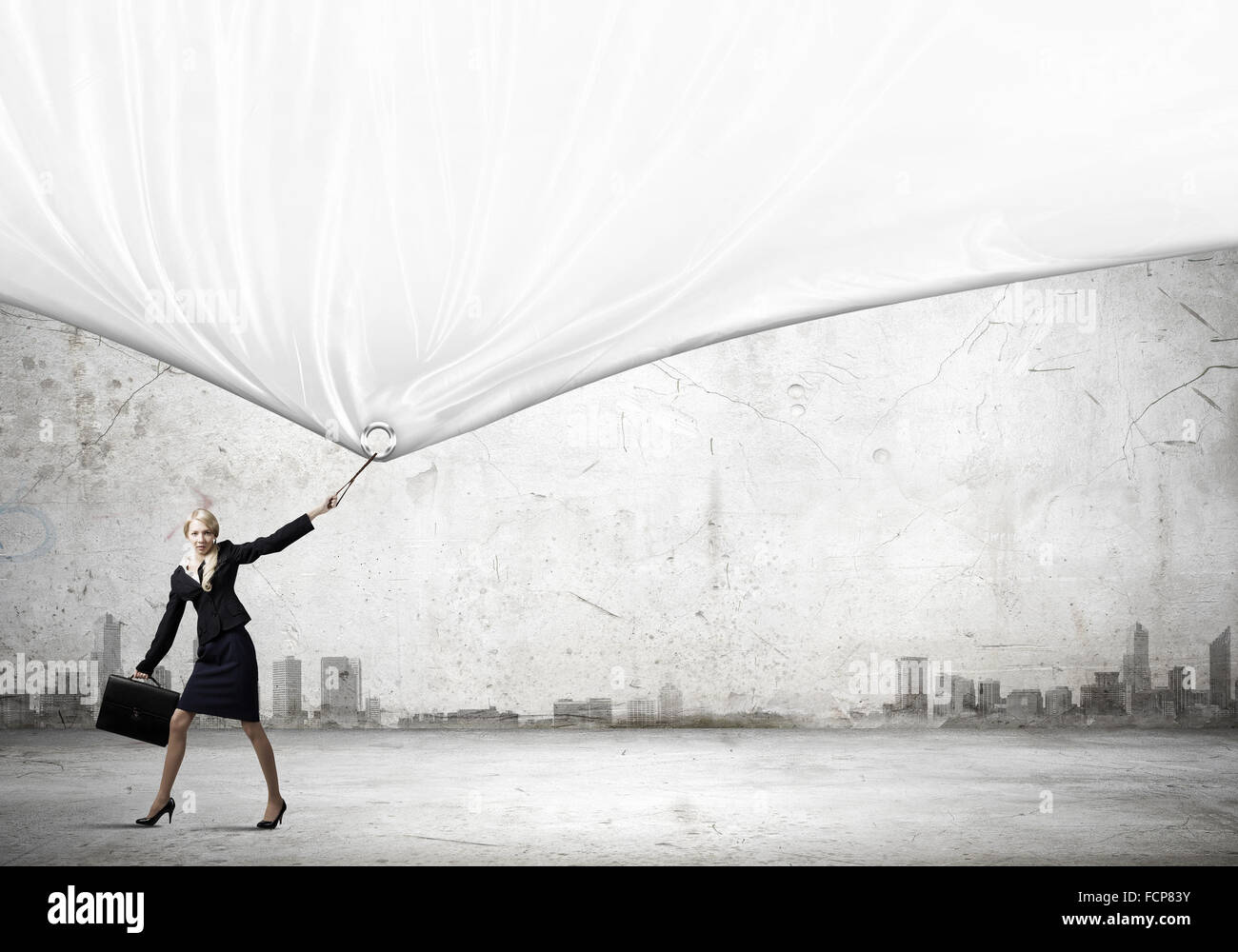 Young businesswoman with suitcase pulling white blank banner Stock ...