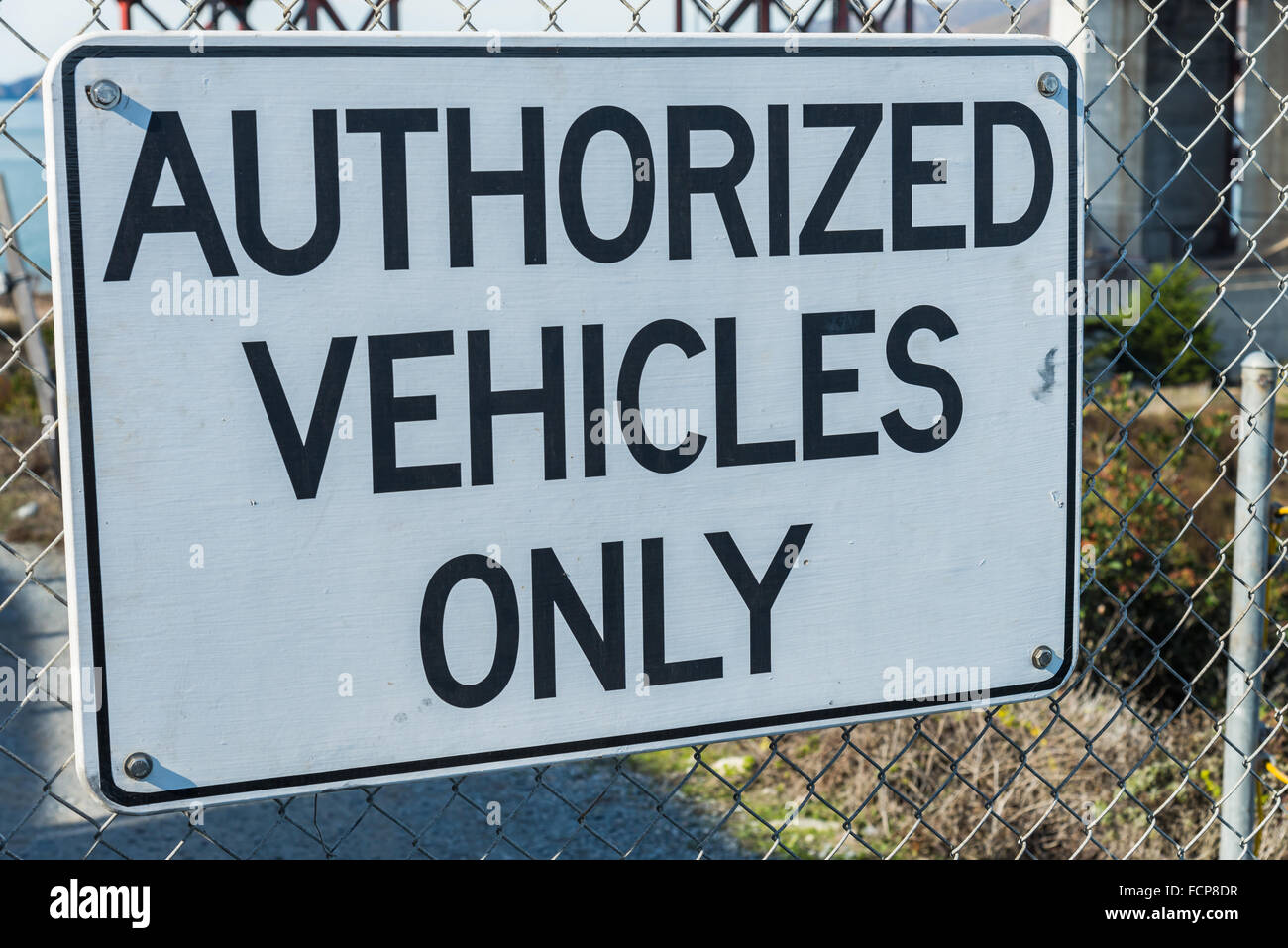 Authorized vehicles only sign on steel fence 2 Stock Photo - Alamy