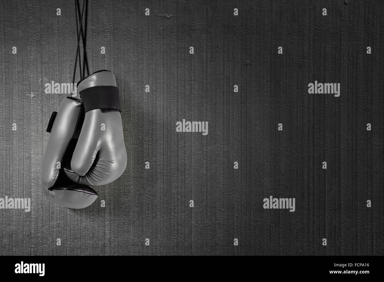 Boxing gloves hanging on nail on wall Stock Photo - Alamy