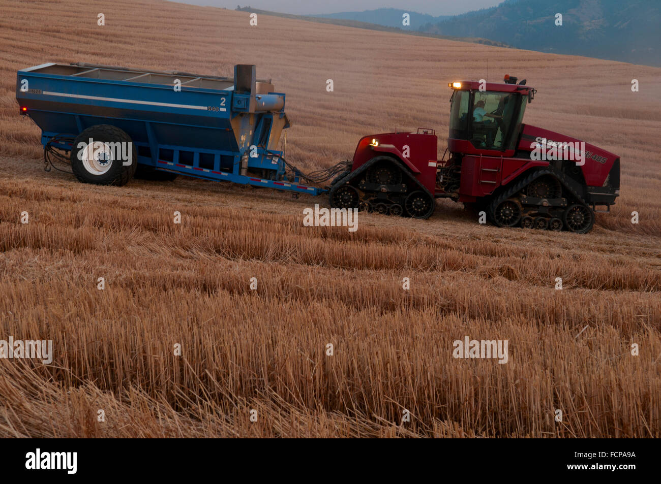 Case track tractor pulling a grain cart during harvest in the Palouse ...