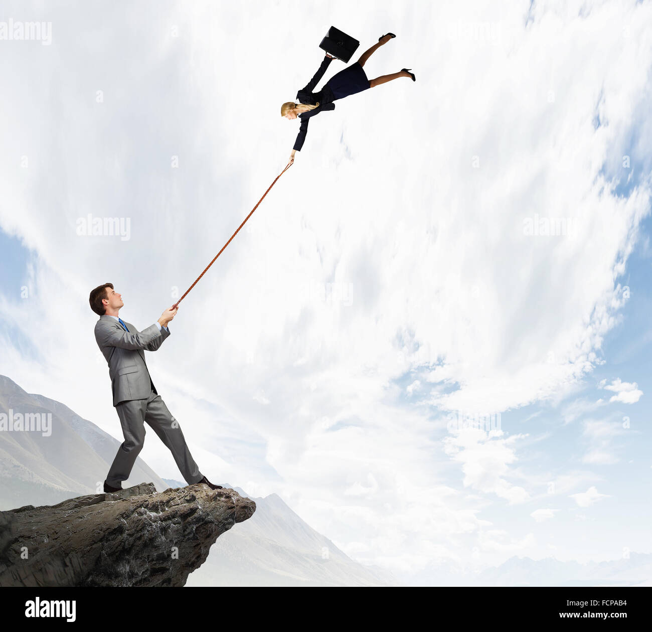 Young man on lead of colleague trying to escape Stock Photo - Alamy
