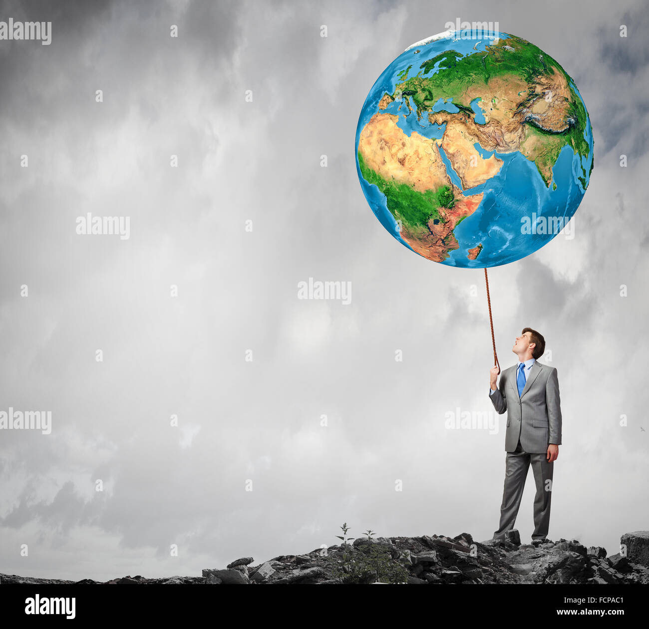 Businessman controlling Earth planet with lead. Elements of this image ...