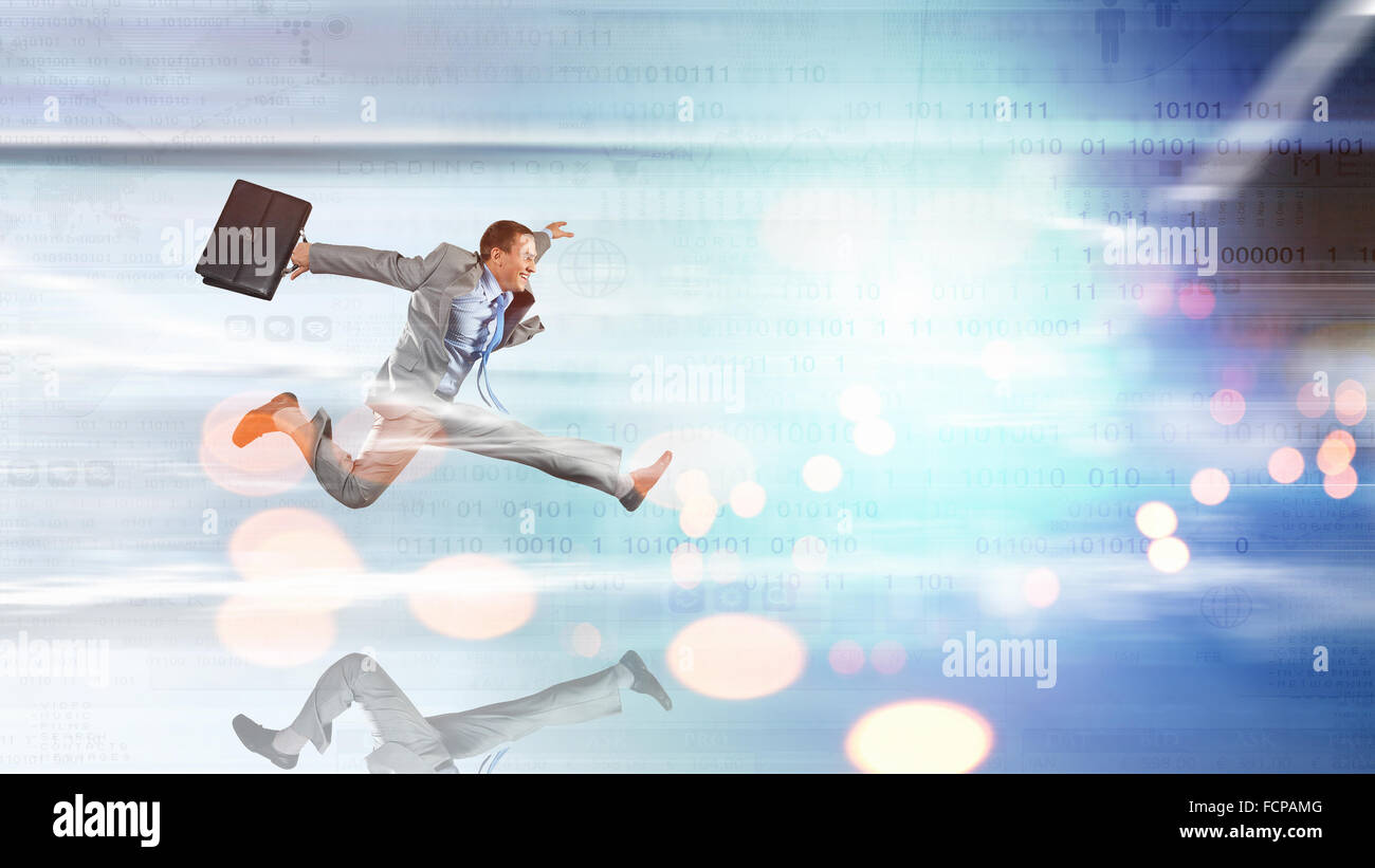 Young businessman in suit running at full pelt Stock Photo - Alamy