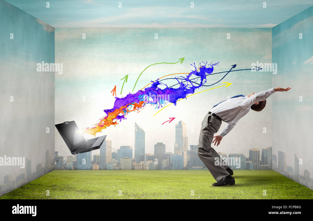 Balancing young man evading from explosion of ideas Stock Photo - Alamy