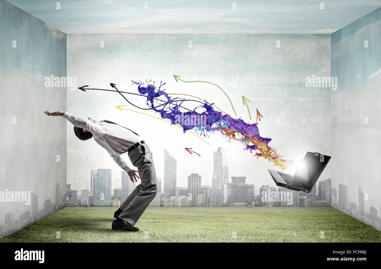 Balancing young man evading from explosion of ideas Stock Photo - Alamy