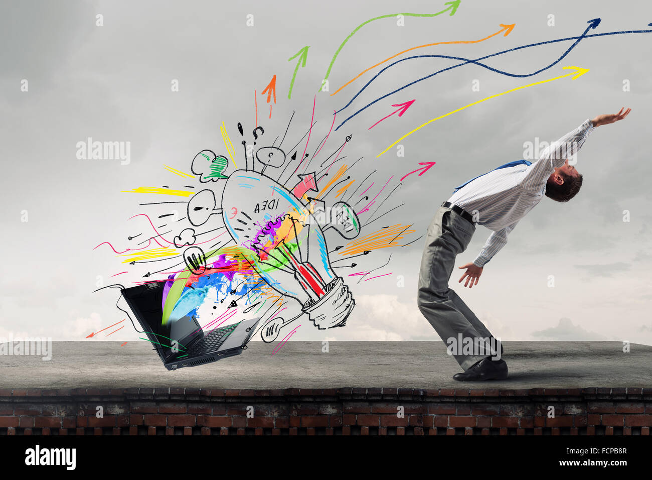 Balancing young man evading from explosion of ideas Stock Photo - Alamy