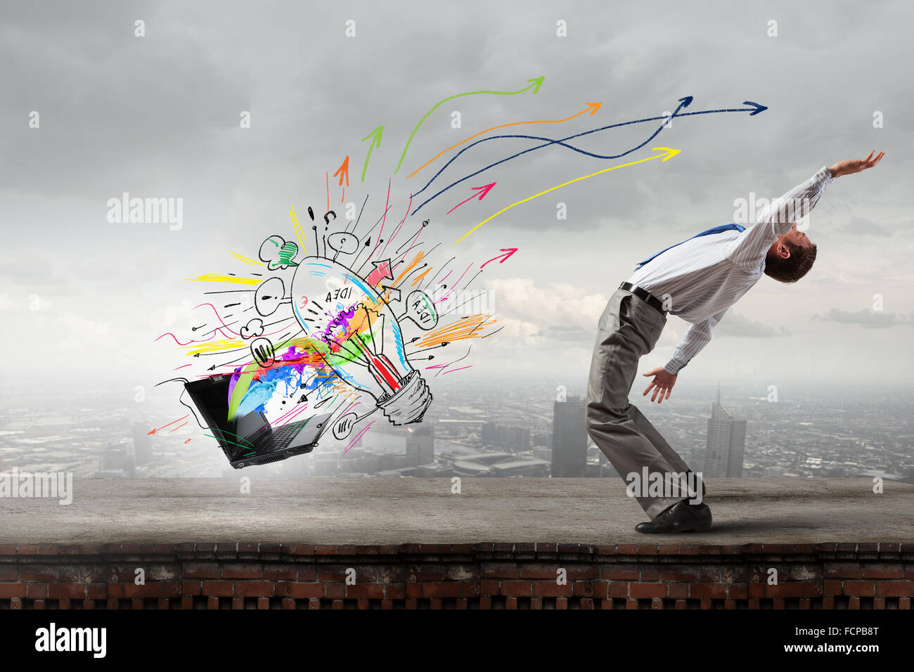 Balancing young man evading from explosion of ideas Stock Photo - Alamy
