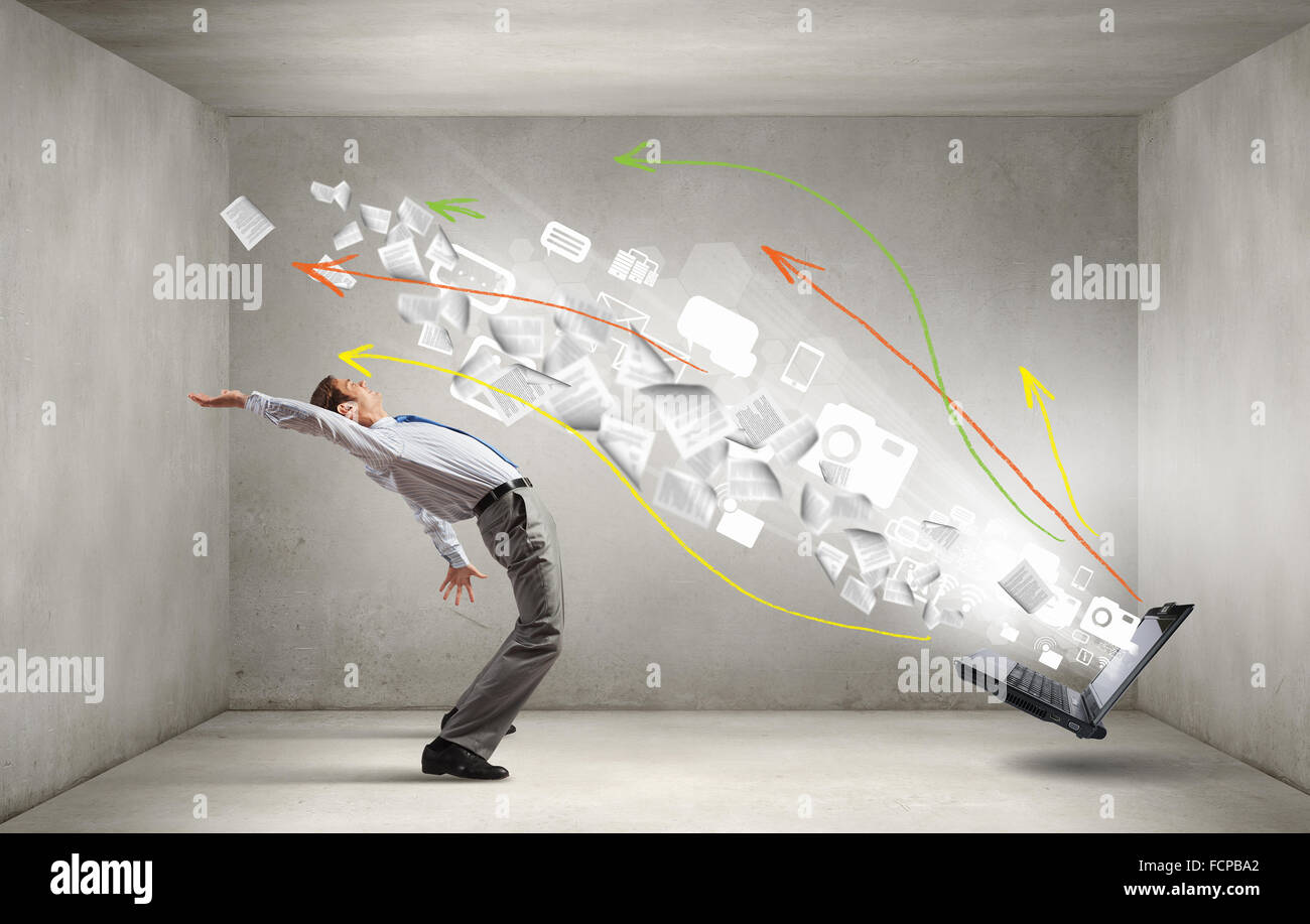 Balancing young man evading from explosion of ideas Stock Photo - Alamy