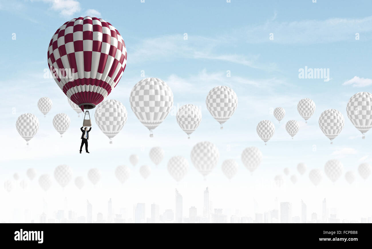 Businessman flying in search of ideas hanging on balloon Stock Photo ...