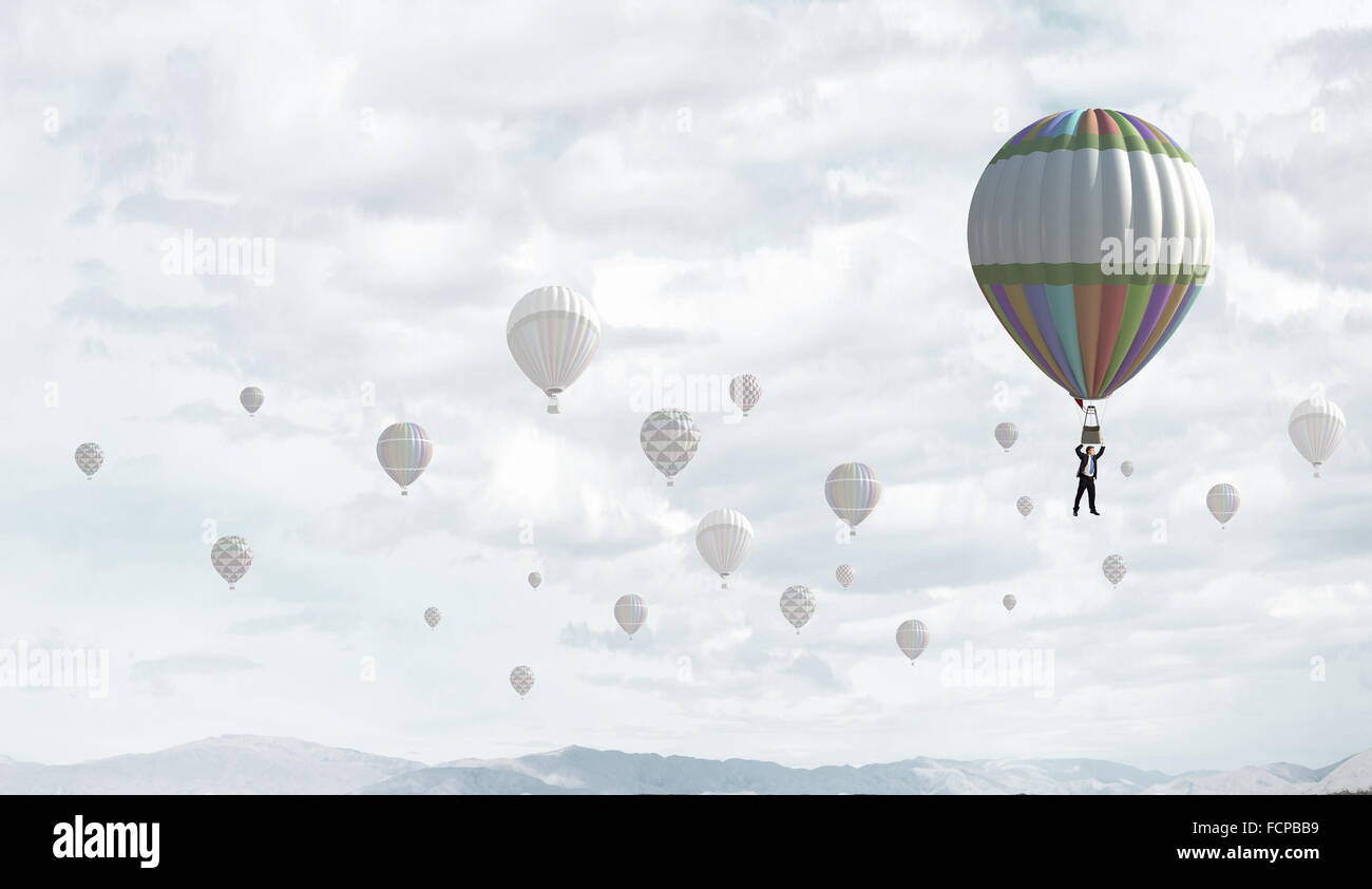 Businessman flying in search of ideas hanging on balloon Stock Photo ...