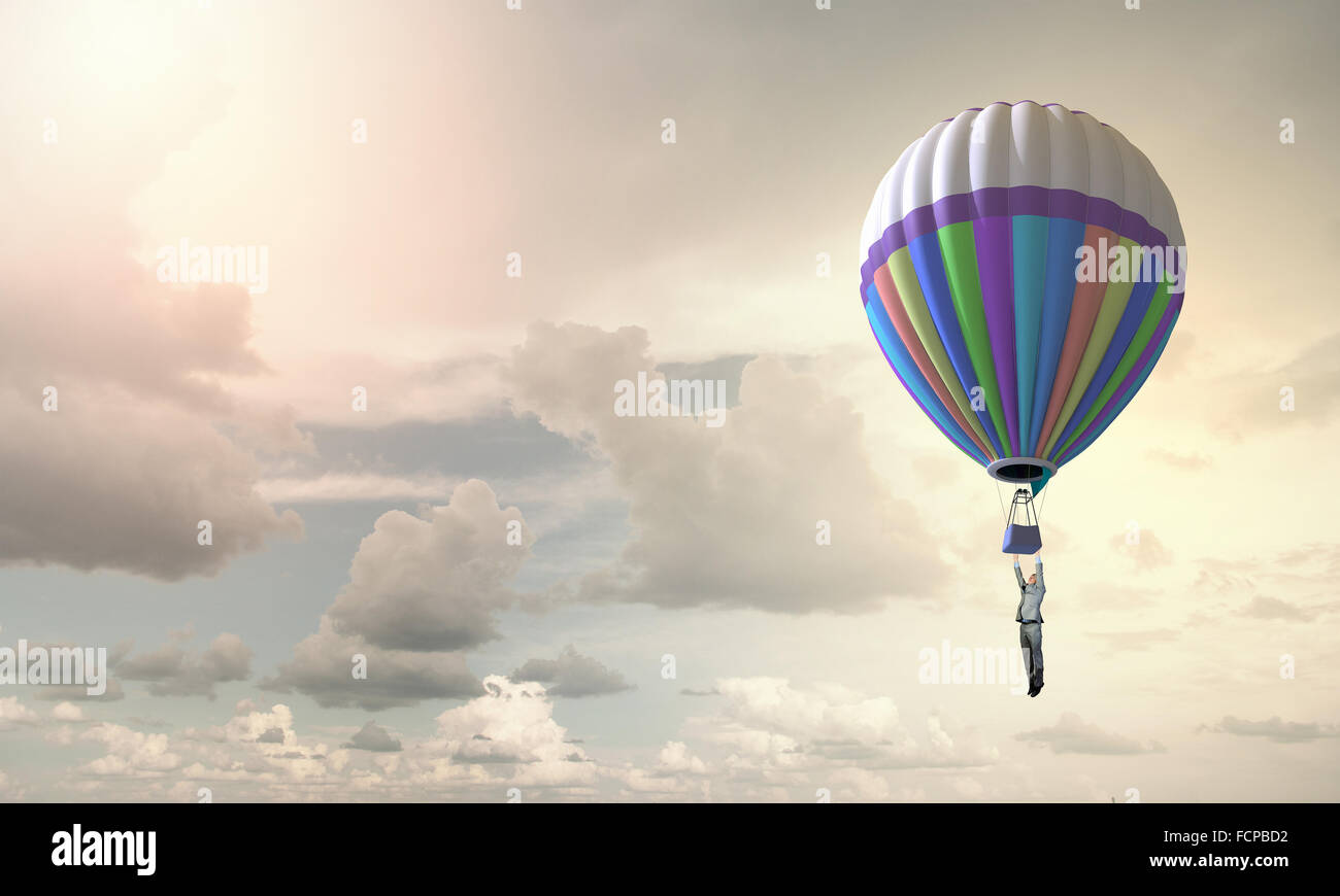 Businessman flying in search of ideas hanging on balloon Stock Photo ...