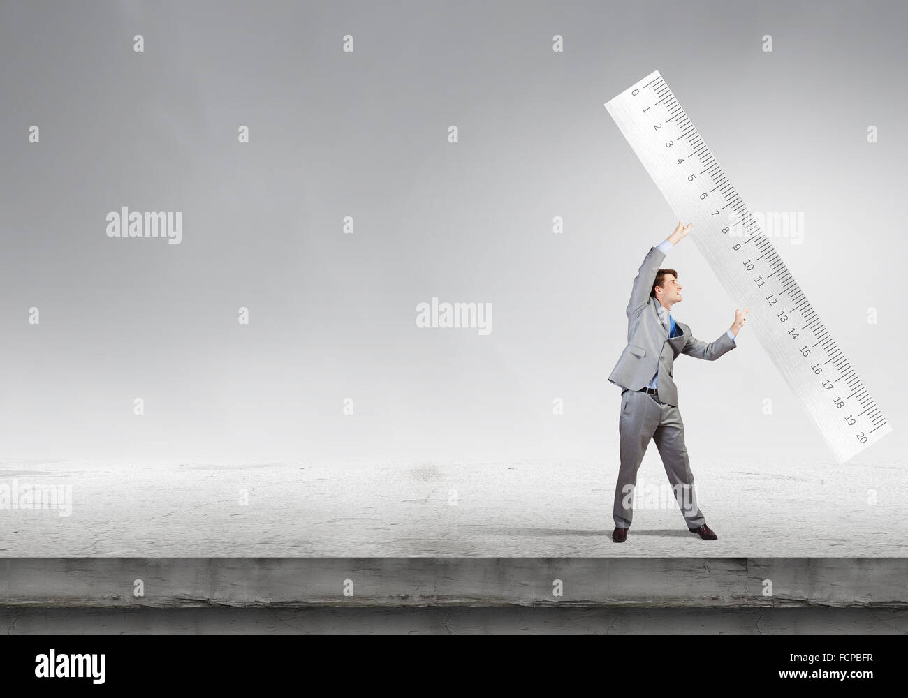 Young businessman in suit measuring ruler benefit Stock Photo - Alamy