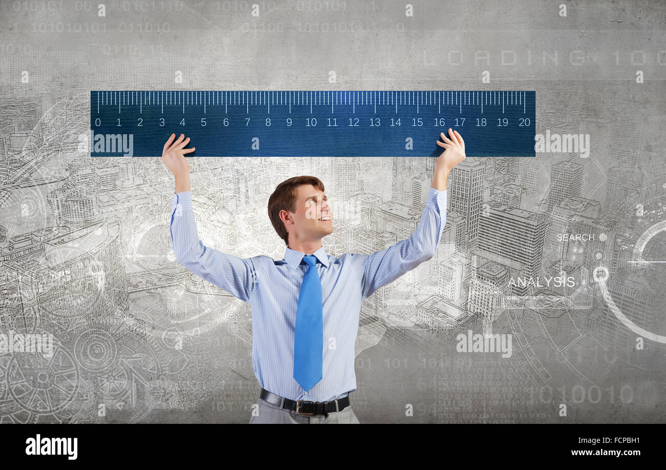 Young businessman in suit measuring ruler benefit Stock Photo - Alamy