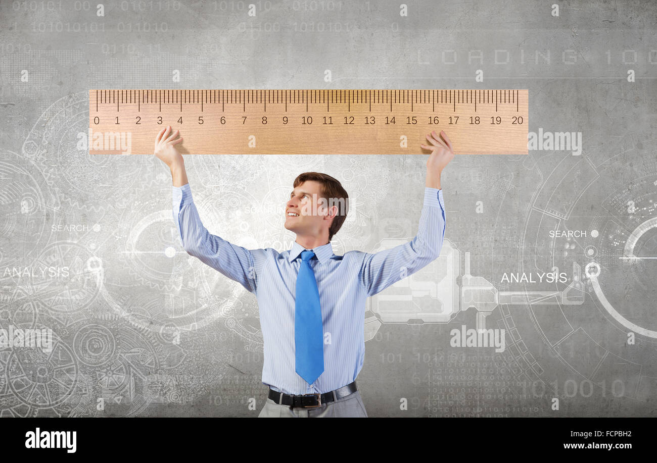 Young businessman in suit measuring ruler benefit Stock Photo - Alamy