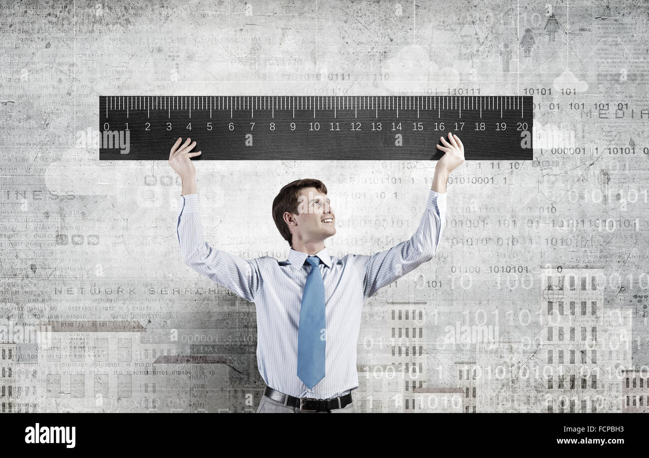 Young businessman in suit measuring ruler benefit Stock Photo - Alamy