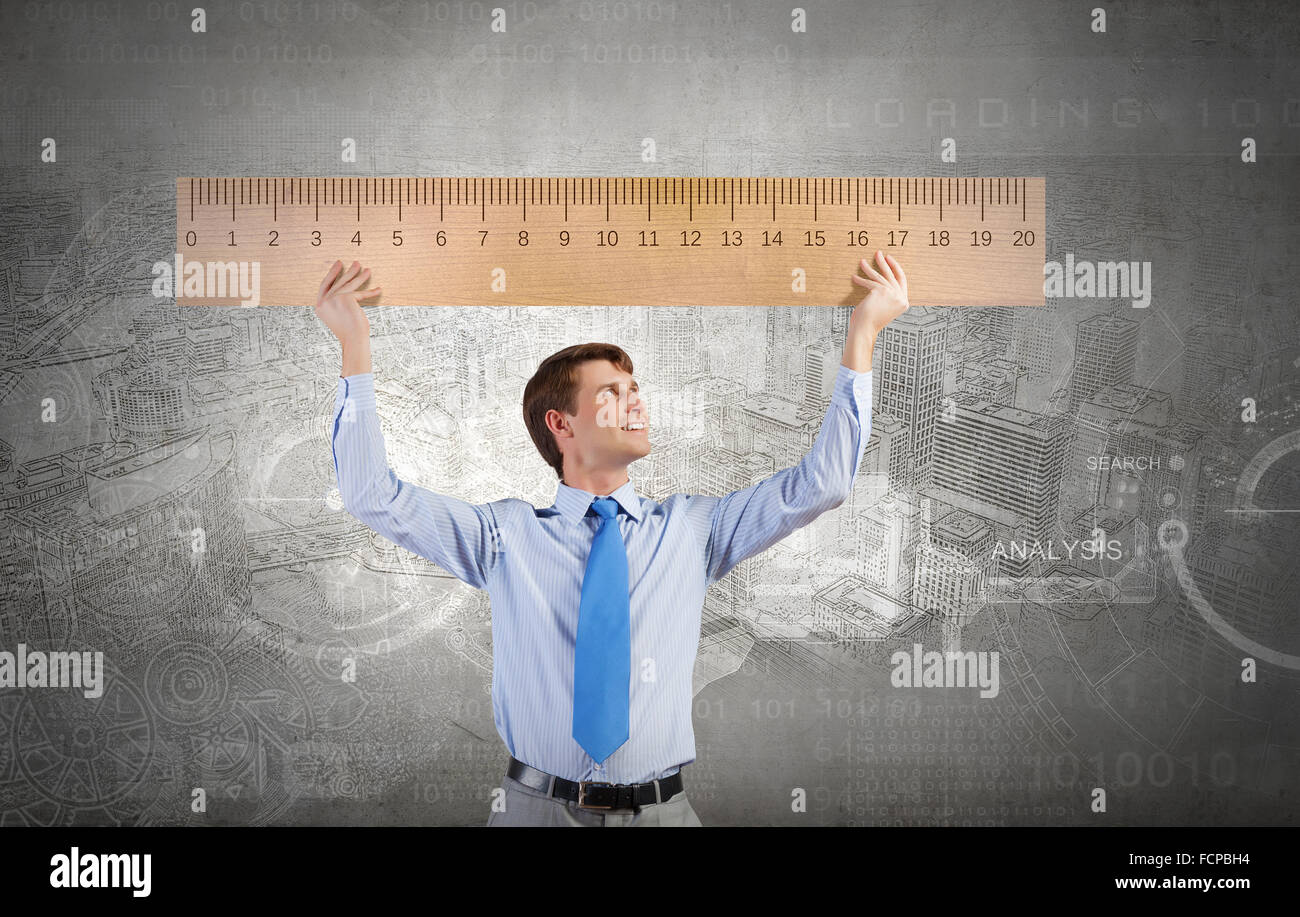 Young businessman in suit measuring ruler benefit Stock Photo - Alamy