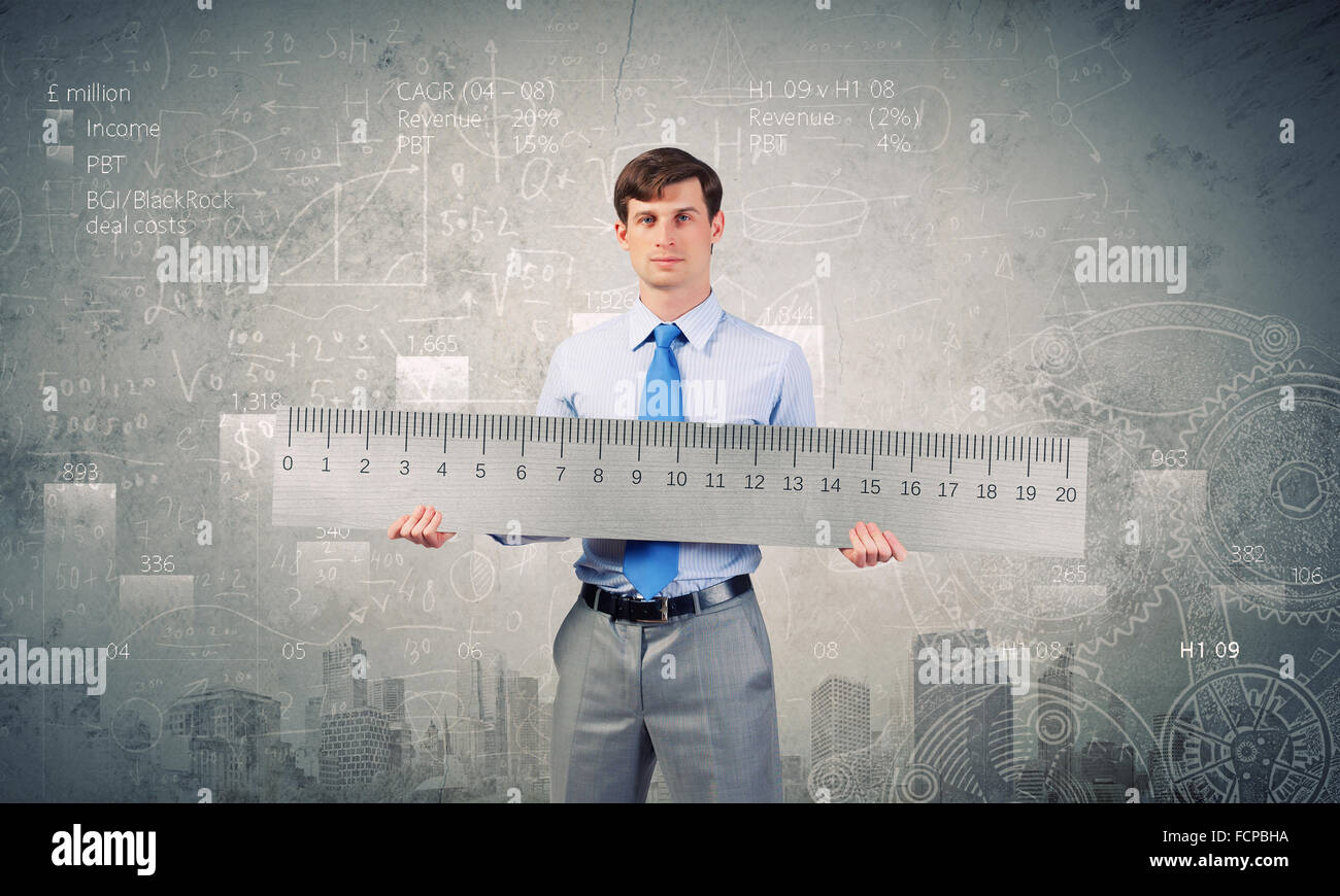 Young businessman in suit measuring ruler benefit Stock Photo - Alamy Young businessman in suit measuring ruler benefit Stock Photo - Alamy