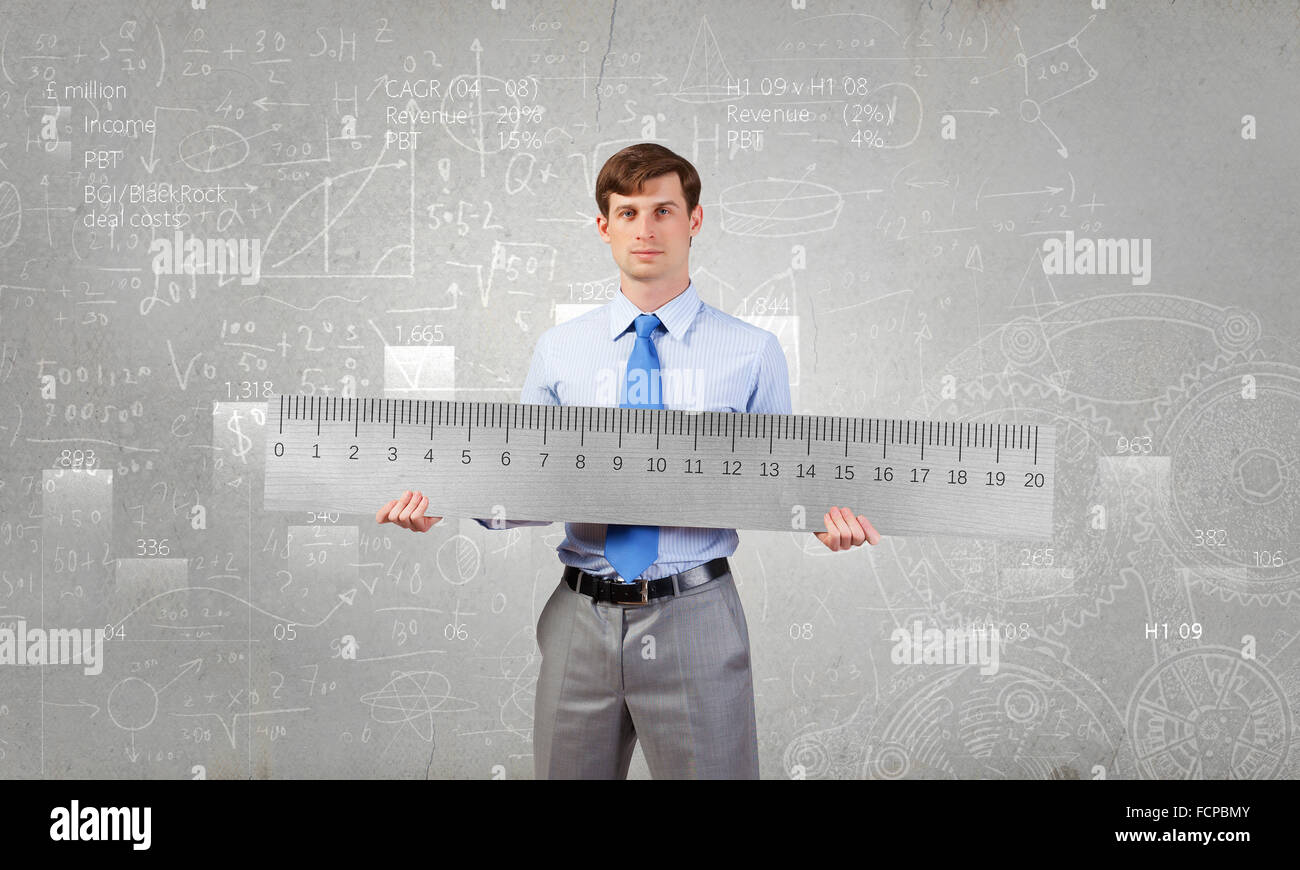 Young businessman in suit measuring ruler benefit Stock Photo - Alamy