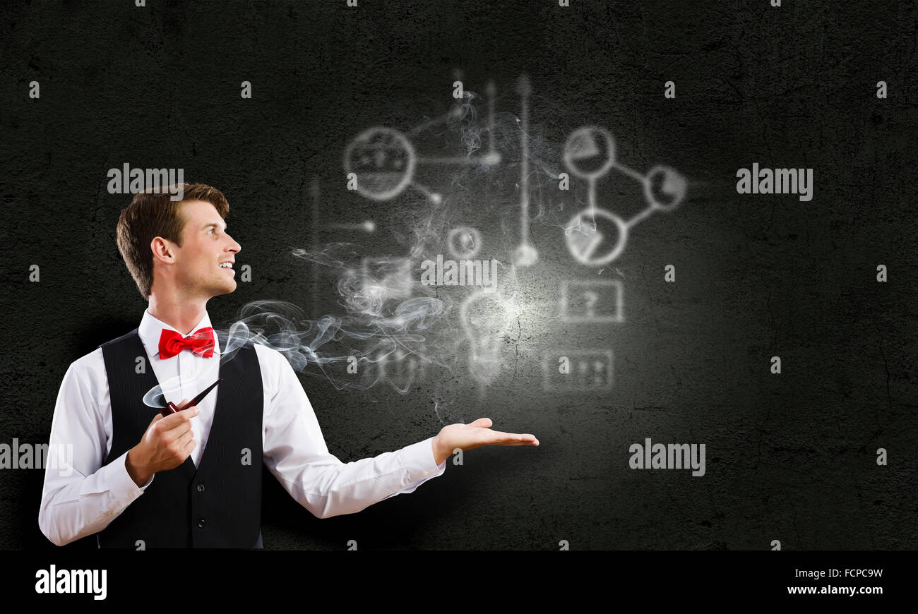 Handsome young businessman thinking over ideas and smoking pipe Stock ...