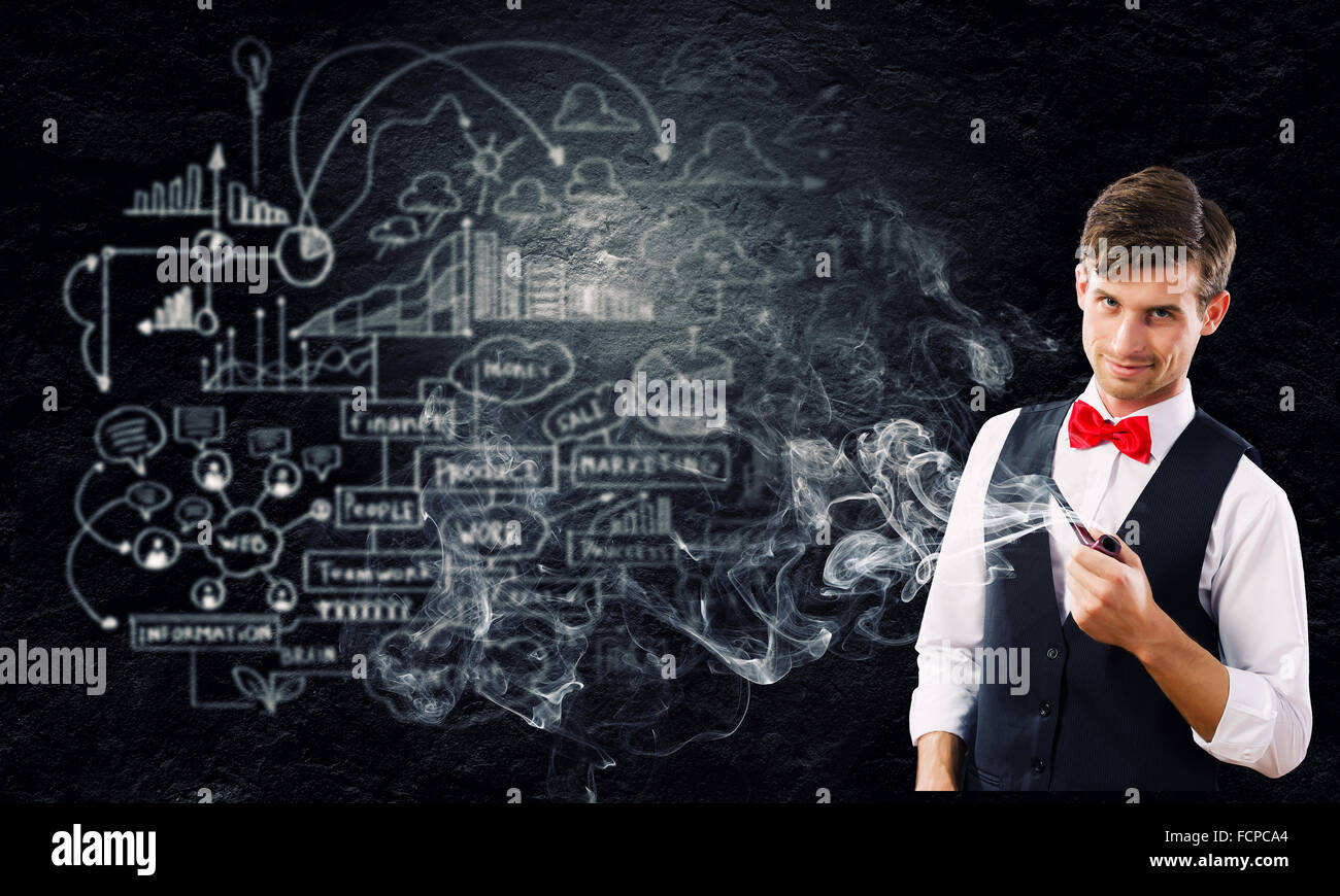 Handsome young businessman thinking over ideas and smoking pipe Stock ...