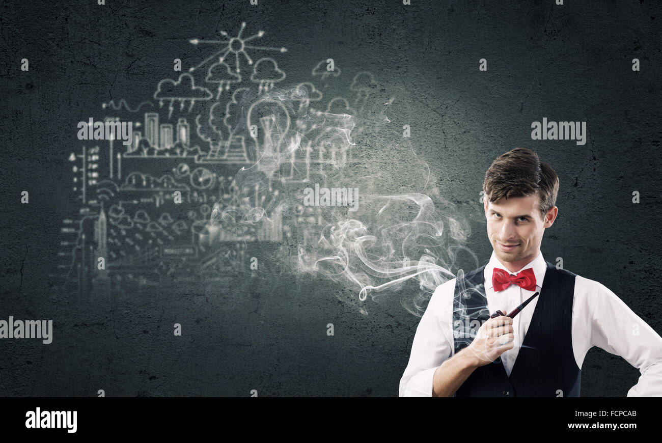 Handsome young businessman thinking over ideas and smoking pipe Stock ...