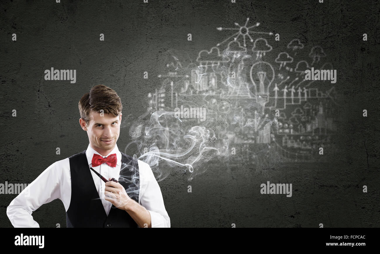 Handsome young businessman thinking over ideas and smoking pipe Stock ...