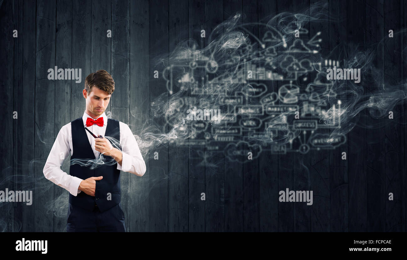 Handsome young businessman thinking over ideas and smoking pipe Stock ...