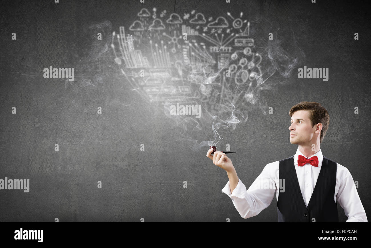 Handsome young businessman thinking over ideas and smoking pipe Stock ...