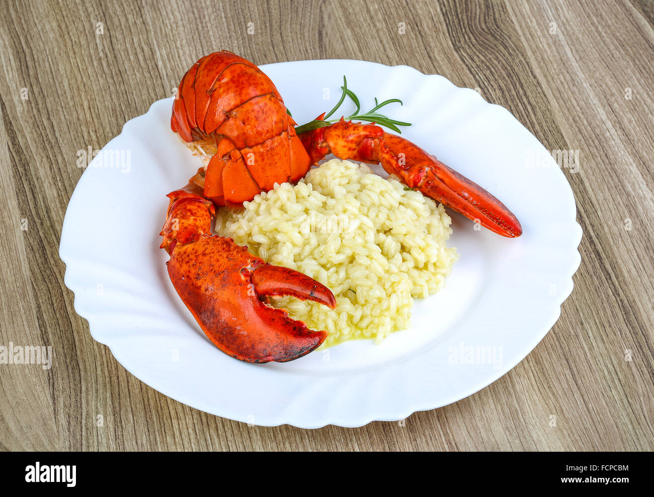 Delicous Risotto with lobster served rosemary and parmesan Stock Photo ...
